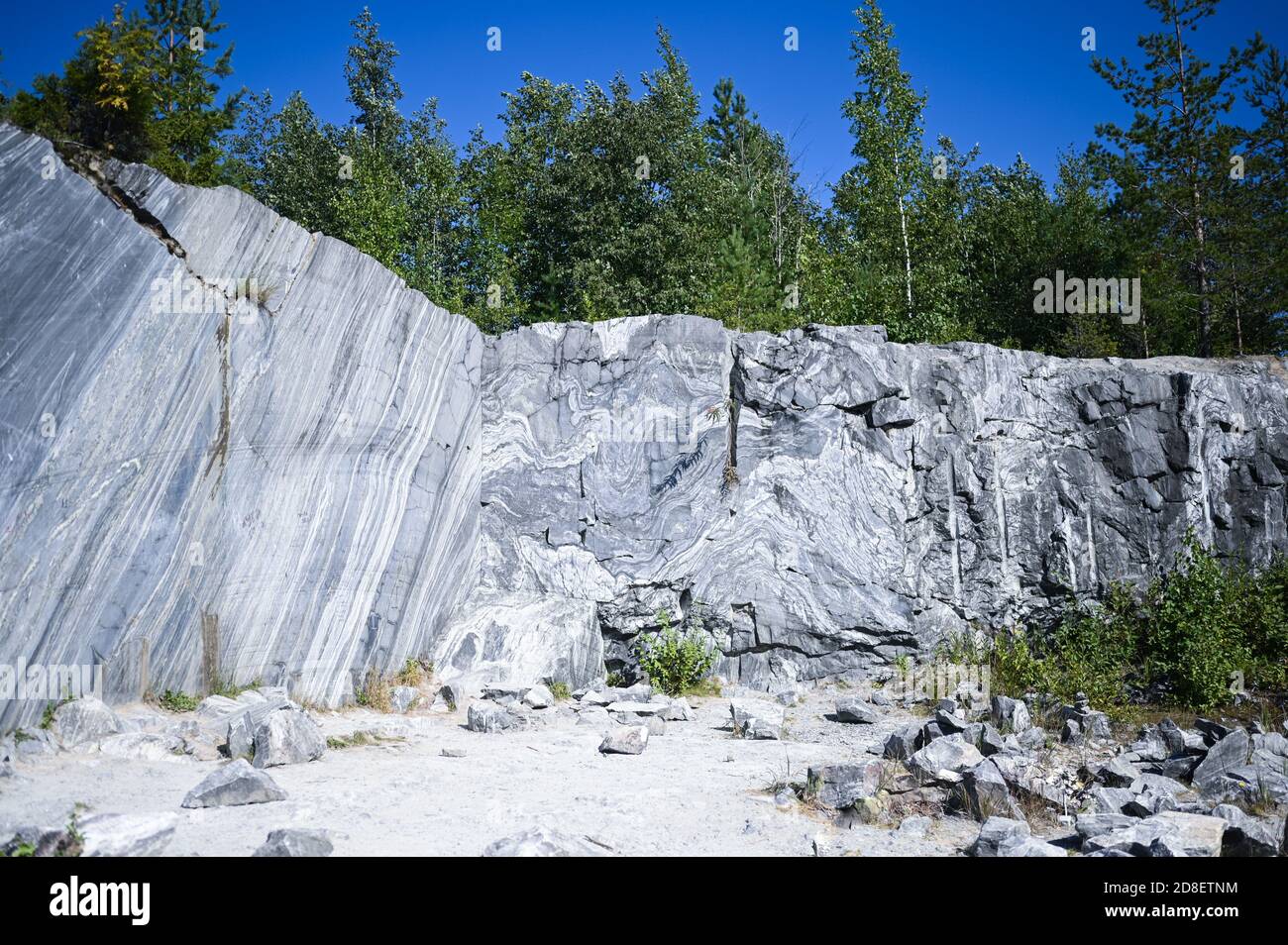 Rock cut raw surface of white and grey marble in the natural ...
