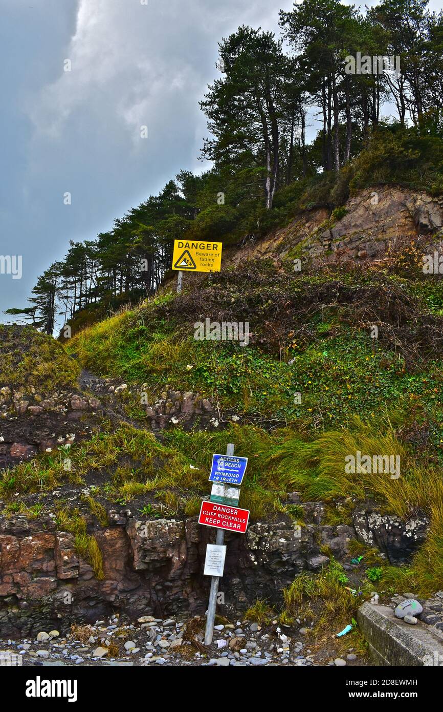 A view of the tree-topped cliffs to the rear of the beach at Amroth ...