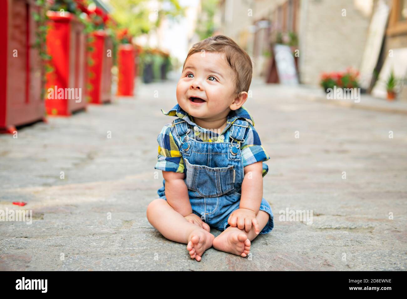 Portrait handsome baby boy sitting on stone street Stock Photo - Alamy