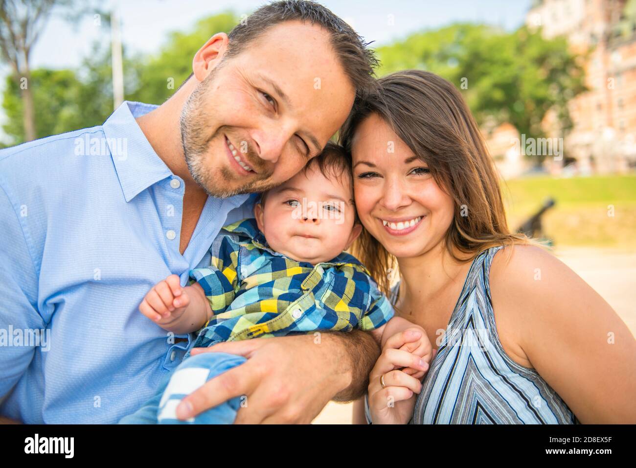 Family of three with baby outside in summer season Stock Photo - Alamy