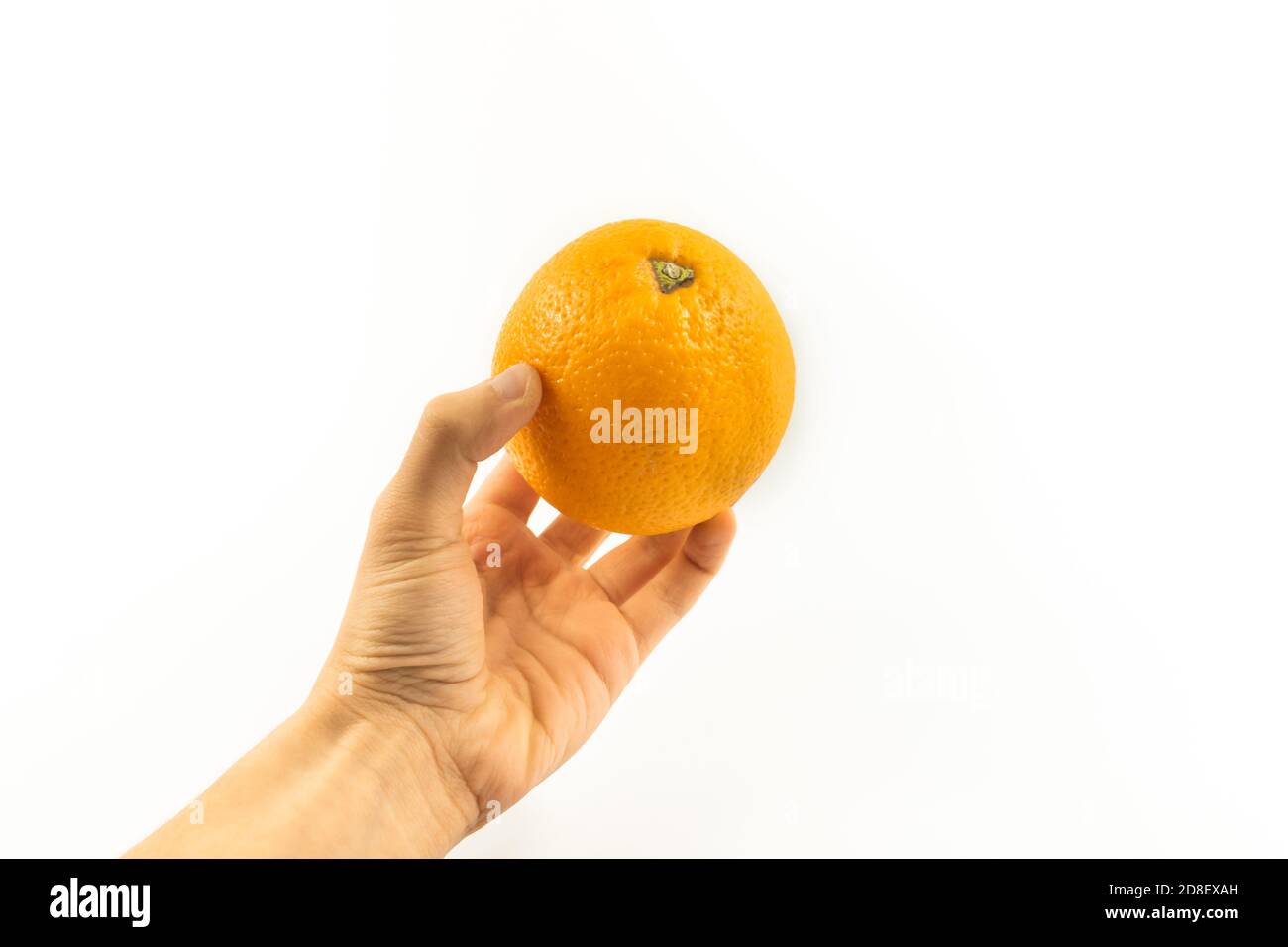 Big orange in hand on white isolated background Stock Photo - Alamy