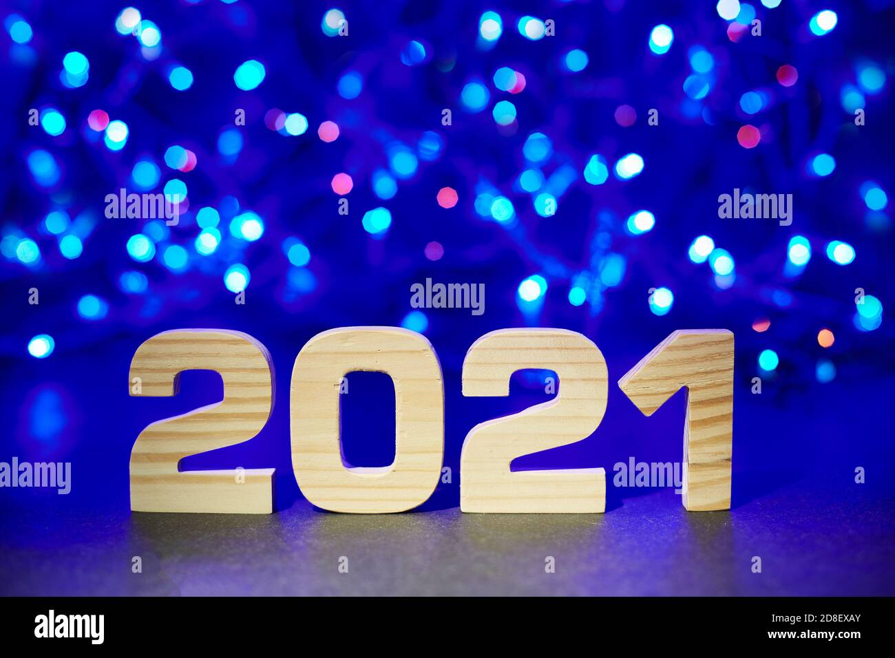 New Year 2021 numbers on a blue background with lights Stock Photo - Alamy