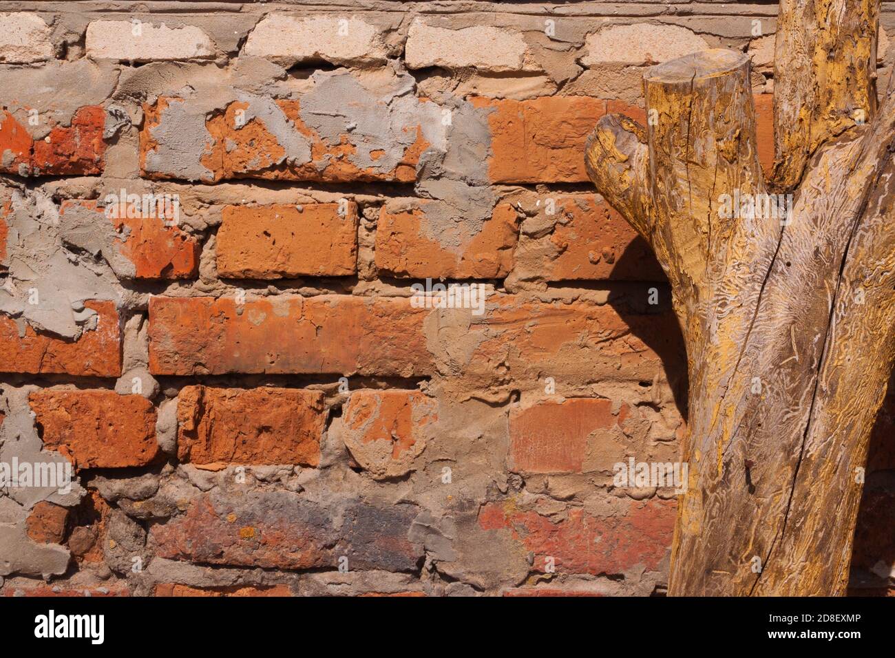 Rough old crumbling orange brickwork. A wall of old broken red bricks ...