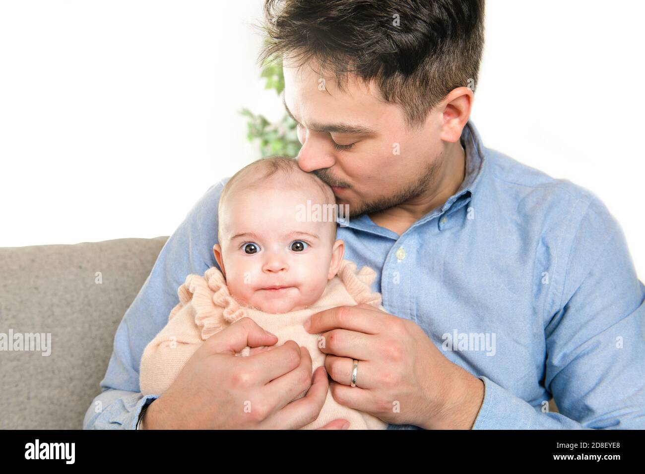 A nice father with baby girl on the sofa Stock Photo - Alamy