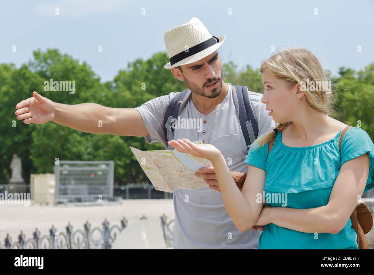 two confused tourists reading a map outdoors Stock Photo - Alamy