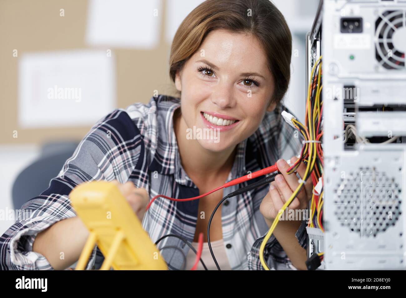 woman checking computer with a multimeter Stock Photo - Alamy