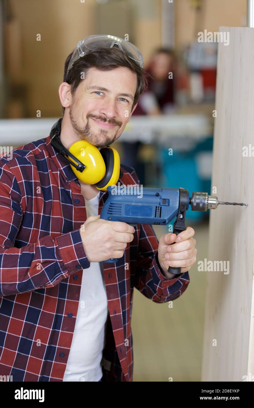Man worker using drill kitchen hi-res stock photography and images - Alamy
