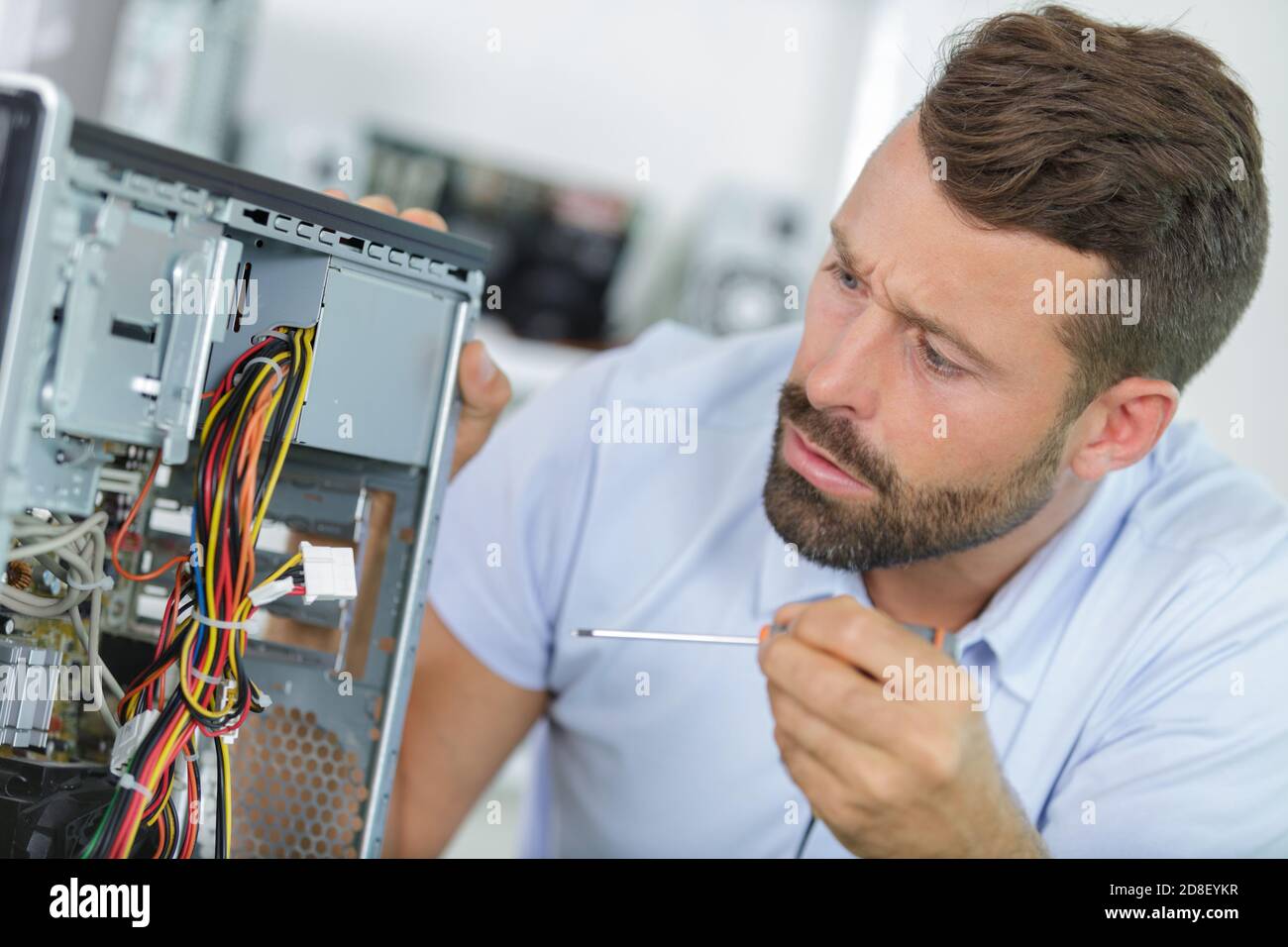 man assembling computer with screw Stock Photo - Alamy