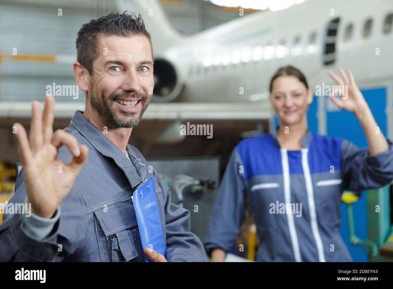 happy mechanics working in auto service Stock Photo - Alamy