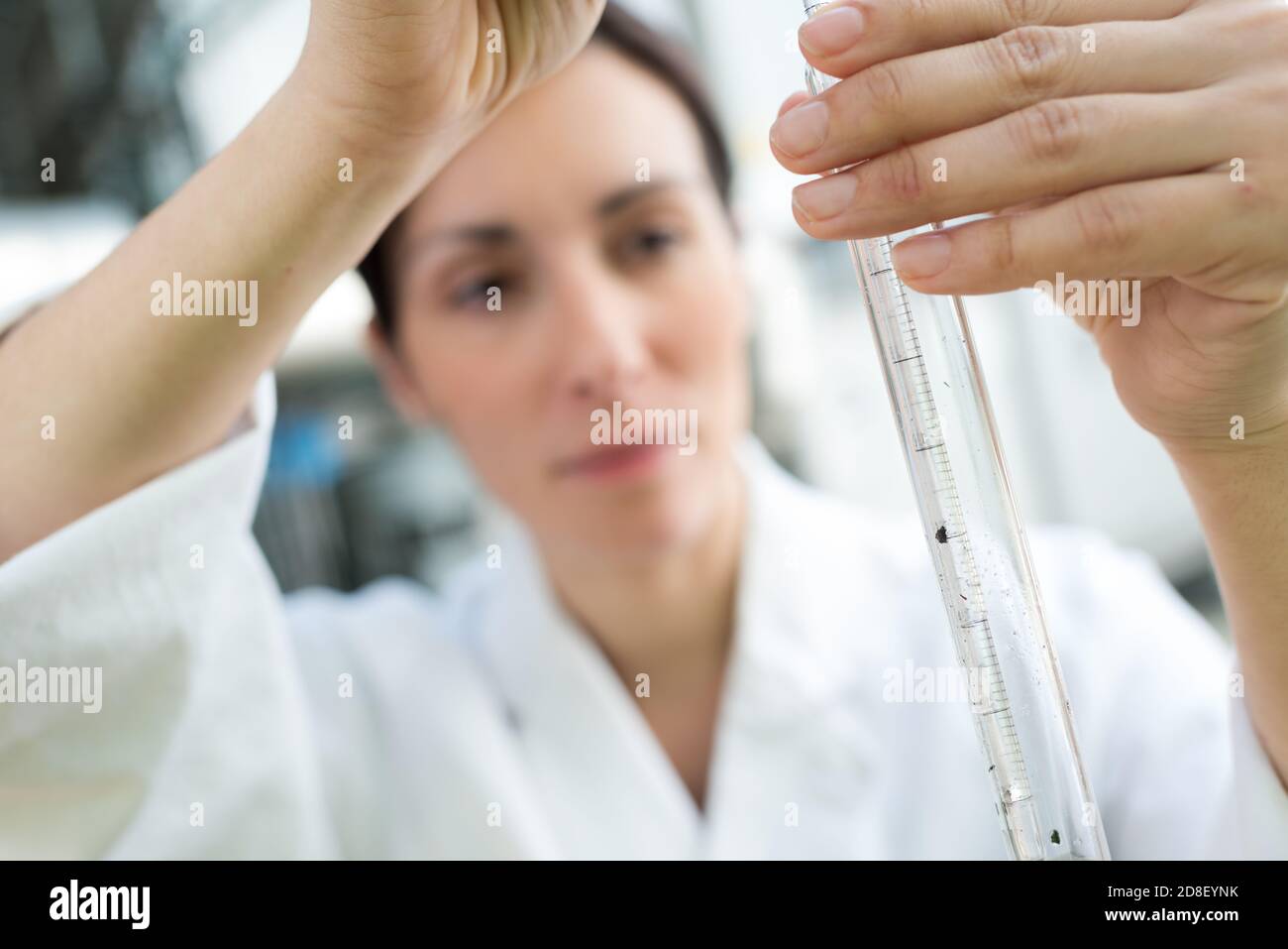 scientist filling graduated test tube Stock Photo - Alamy
