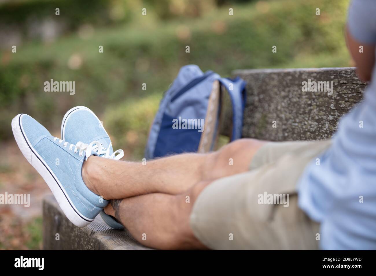Man sitting feet bench hi-res stock photography and images - Alamy