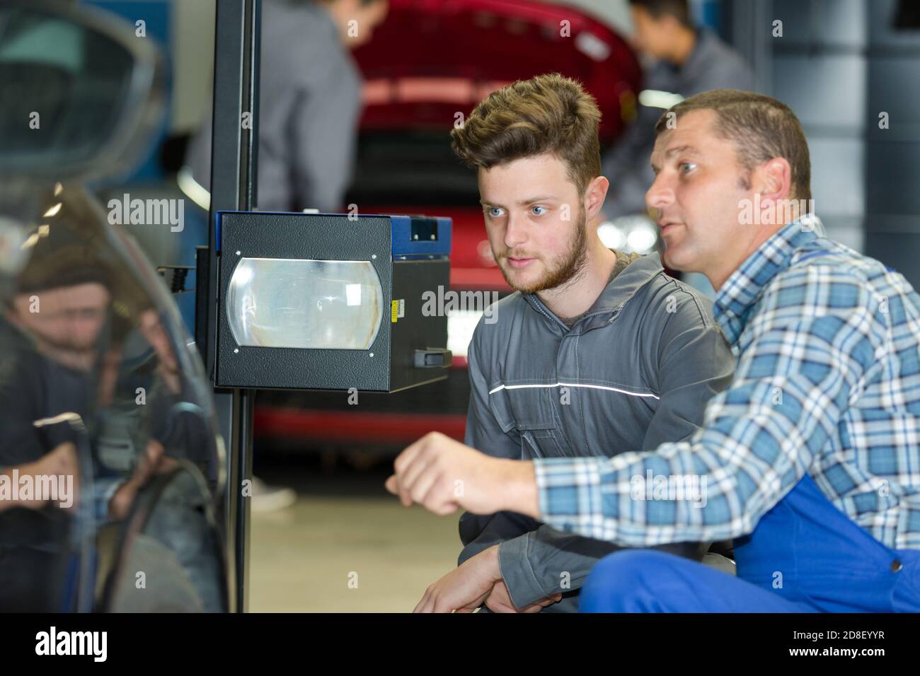 mechanics testing car lights in garage Stock Photo - Alamy