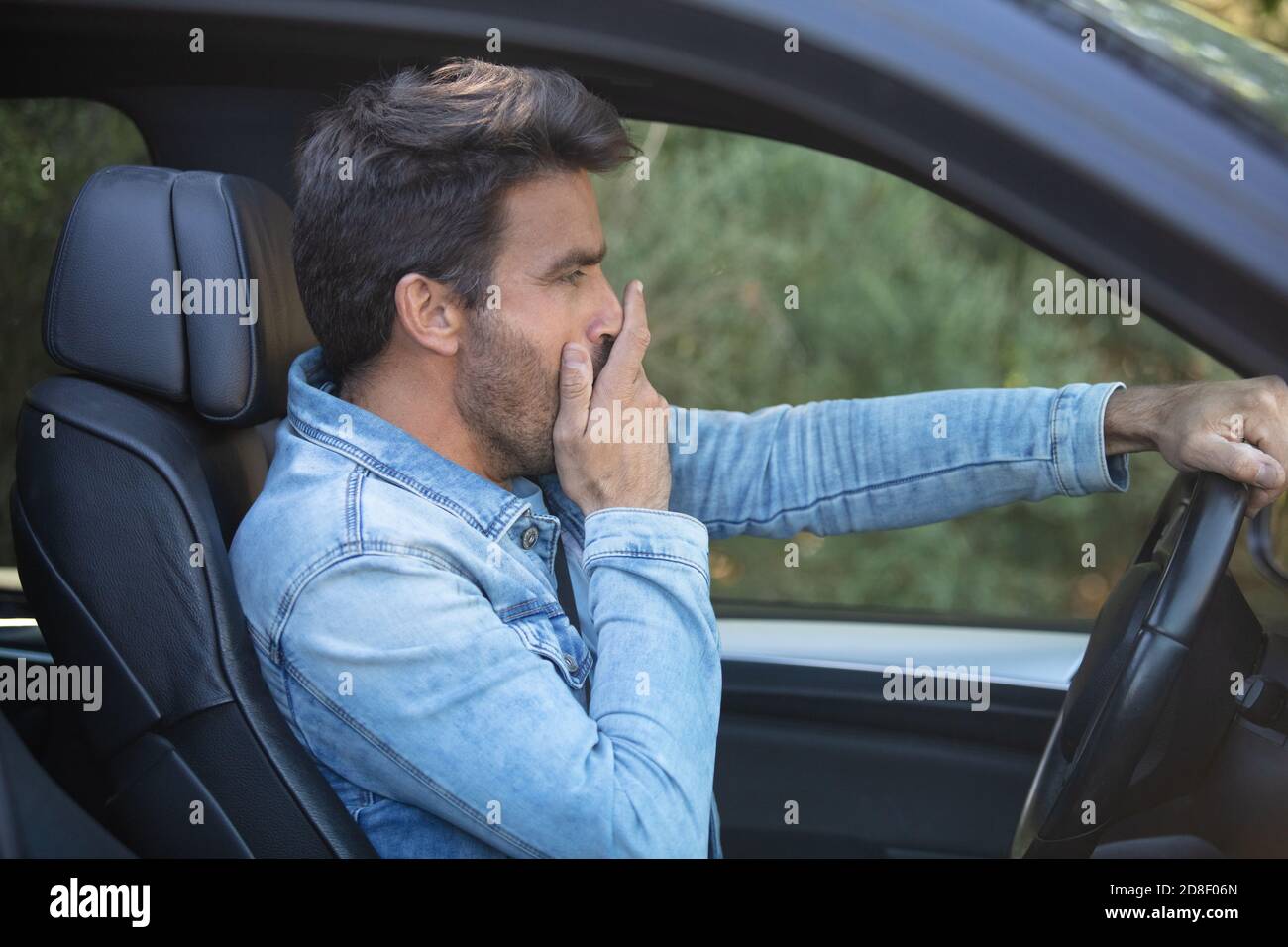 tired young man driving his car Stock Photo - Alamy