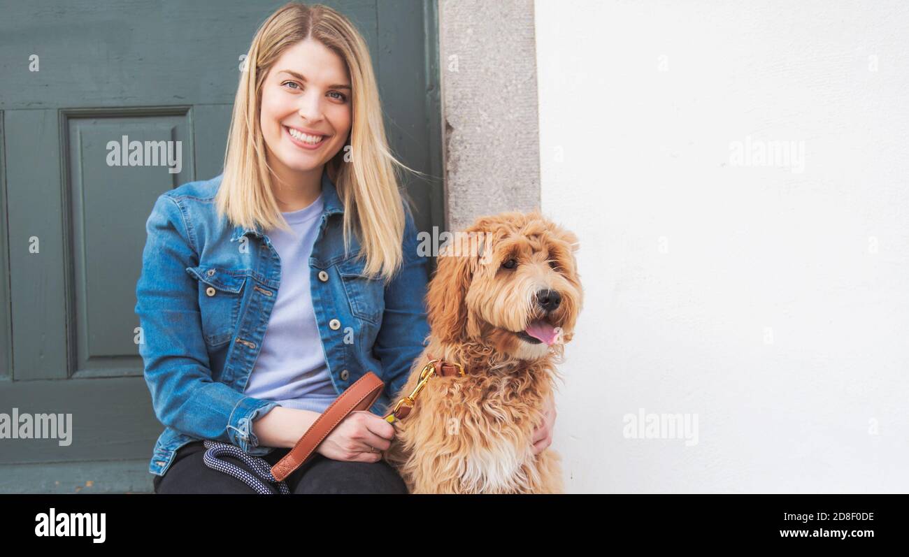 Labradoodle Dog and woman outside on balcony Stock Photo - Alamy