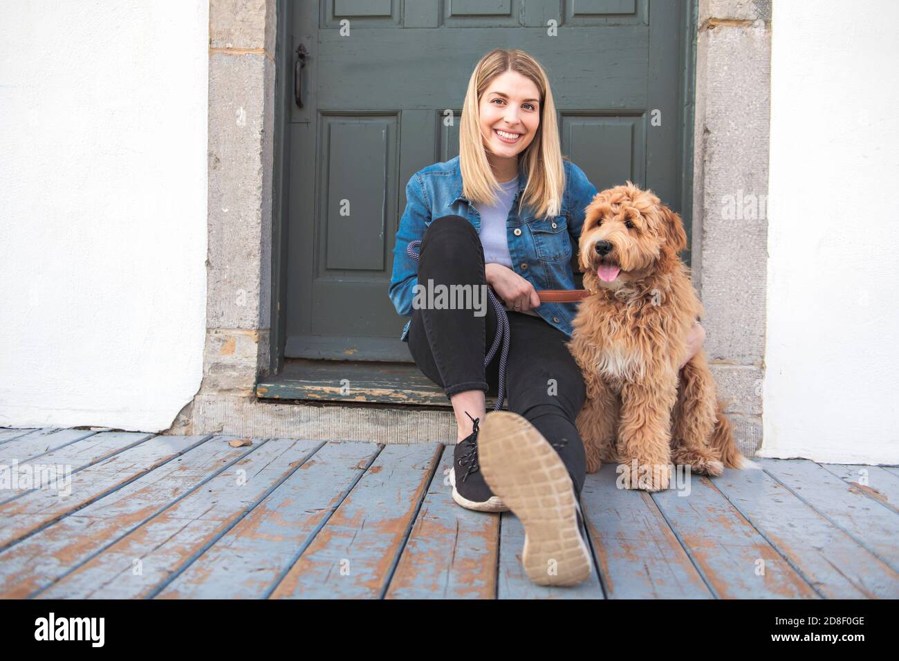 Labradoodle Dog and woman outside on balcony Stock Photo - Alamy
