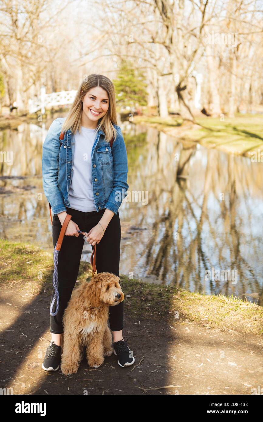 Happy Labradoodle Dog and woman outside at the park Stock Photo - Alamy