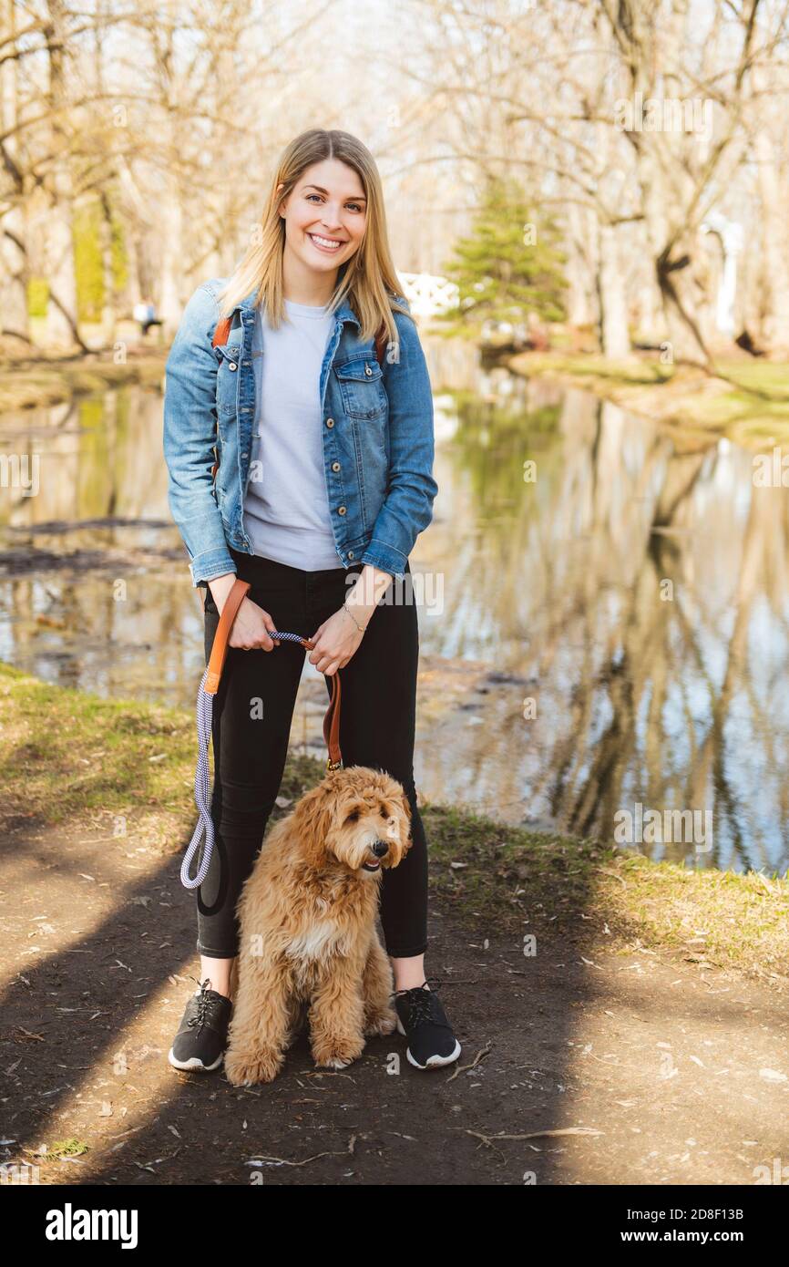 Happy Labradoodle Dog and woman outside at the park Stock Photo - Alamy