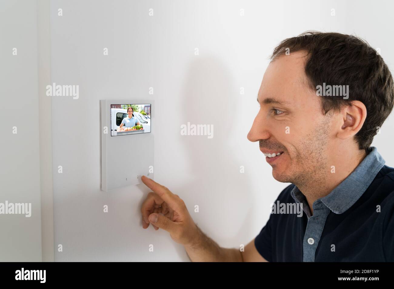 Man Using Video Intercom Entrance Safety System Stock Photo - Alamy