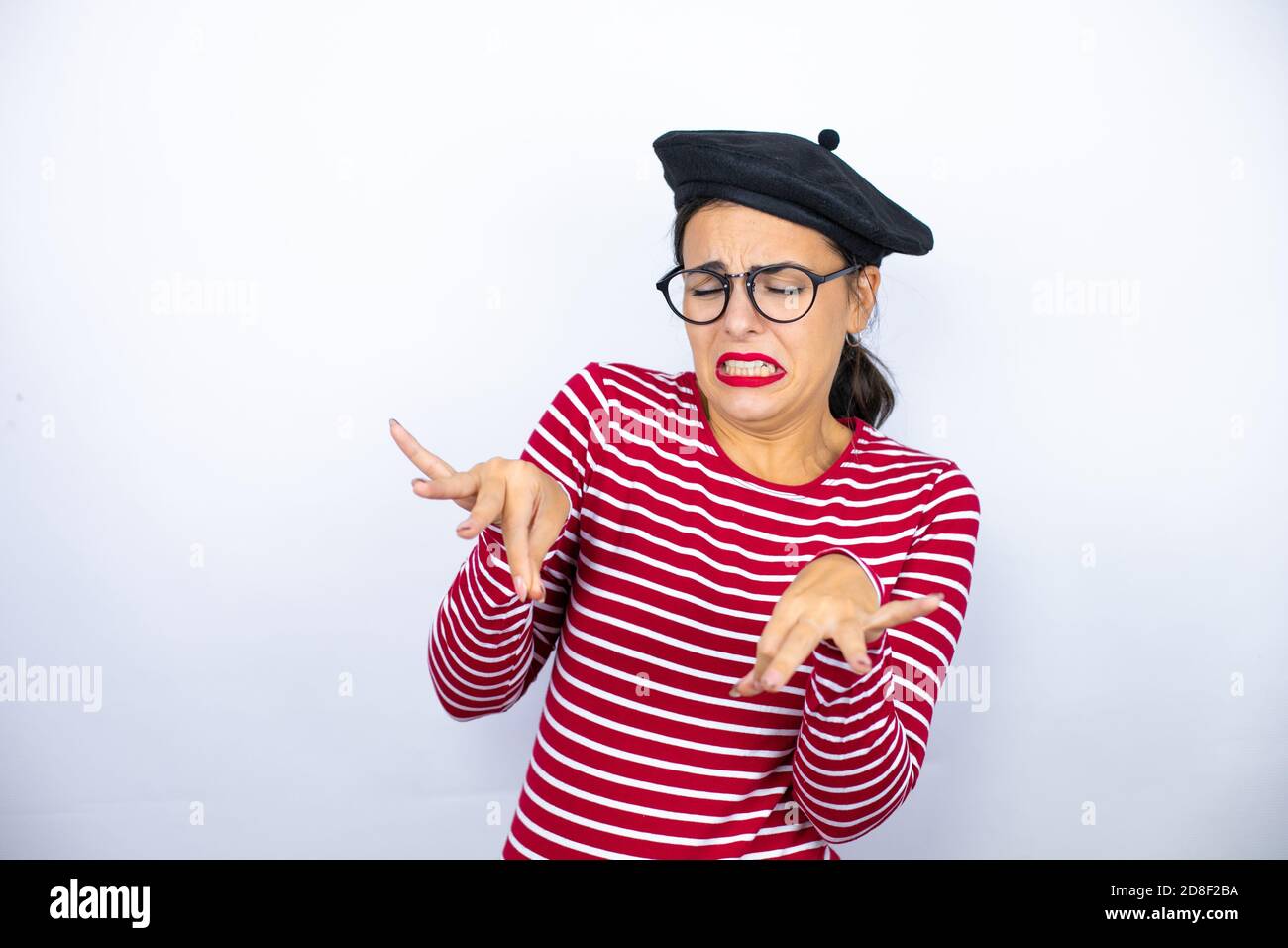 Young beautiful brunette woman wearing french beret and glasses over ...