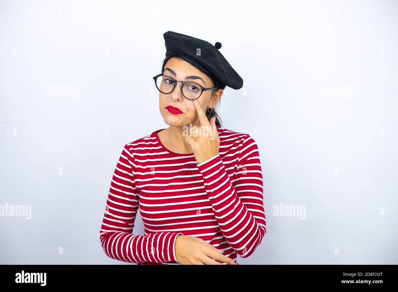 Young beautiful brunette woman wearing french beret and glasses over ...