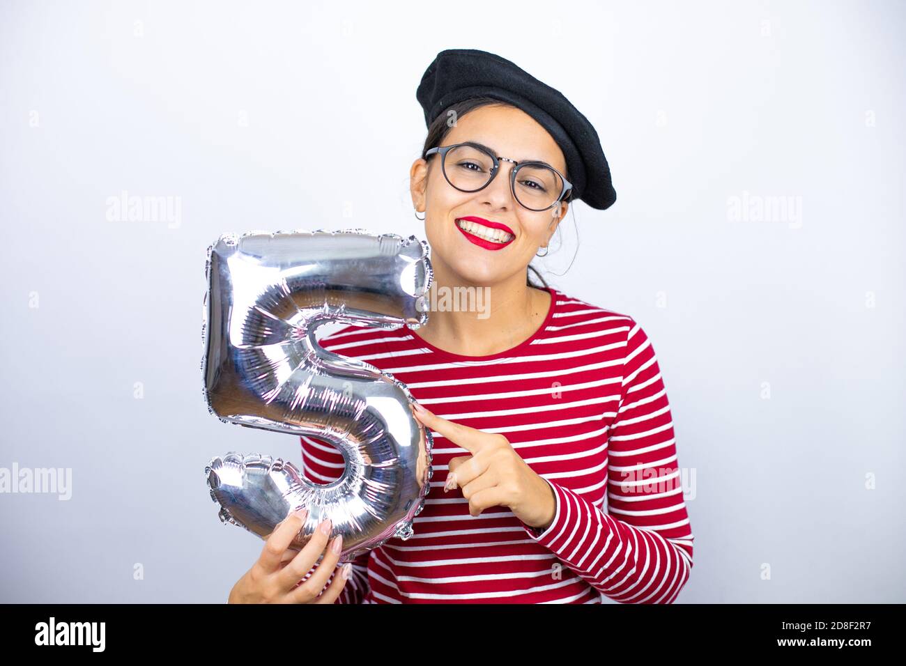Young beautiful brunette woman wearing french beret and glasses over ...