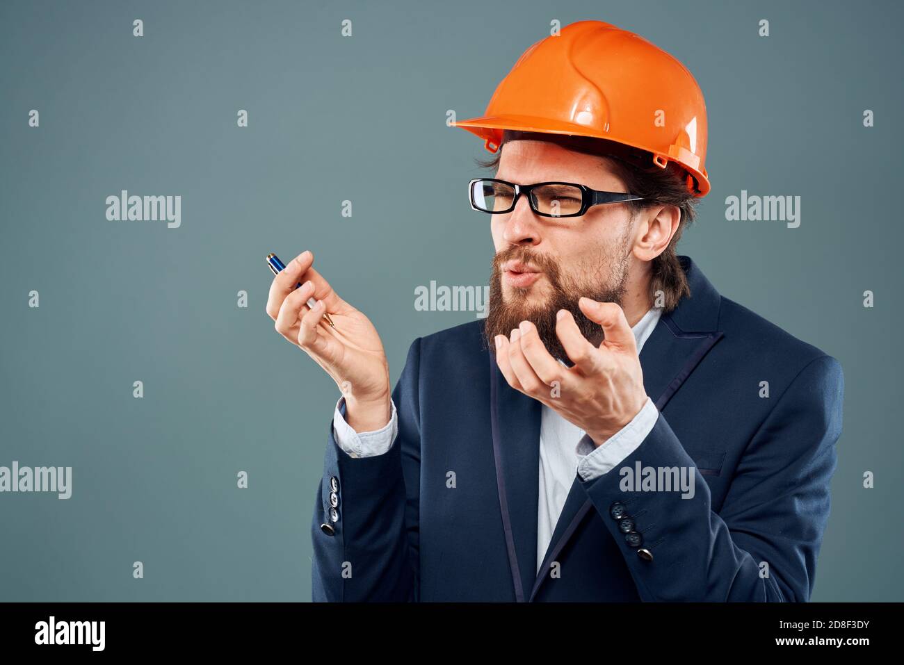 A man wearing an orange hard hat industry official job Stock Photo - Alamy
