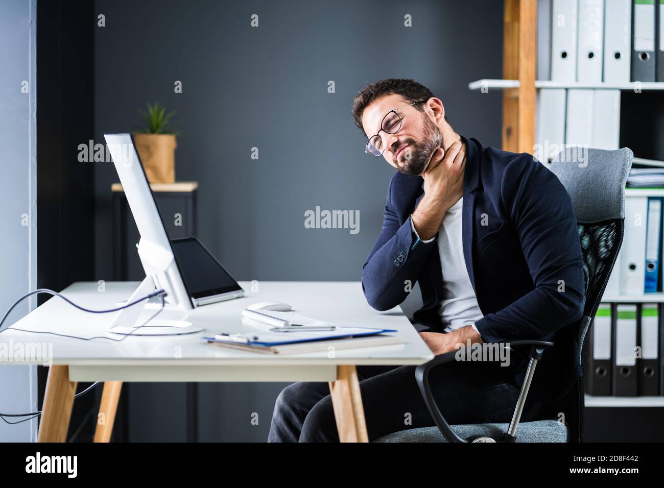 Young Man With Tense Neck Pain. Office Posture Problem Stock Photo - Alamy