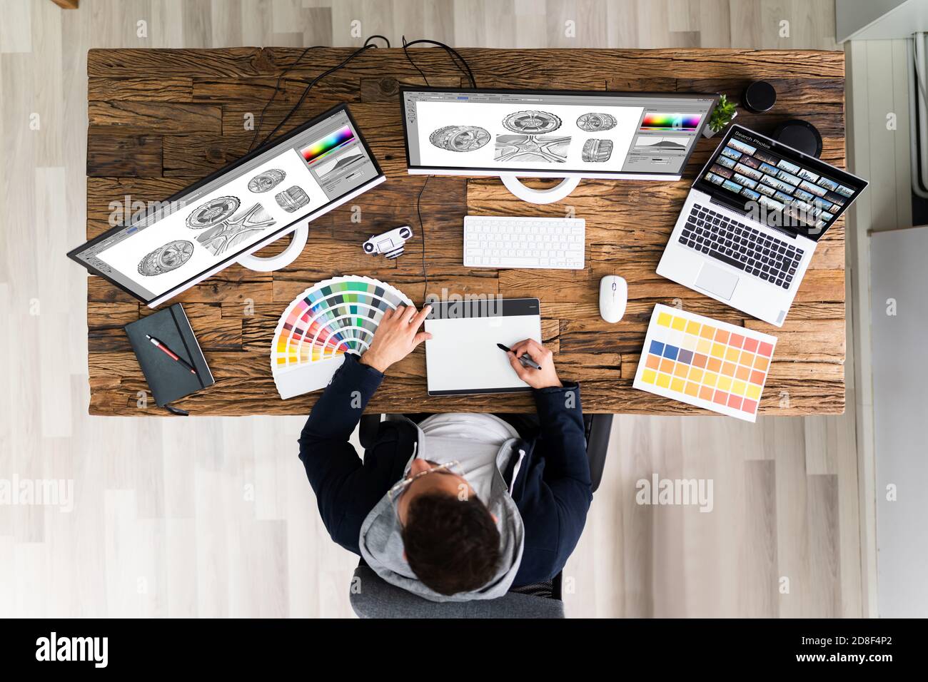 Designer Editing Photos On Multiple Computer Screens Stock Photo - Alamy
