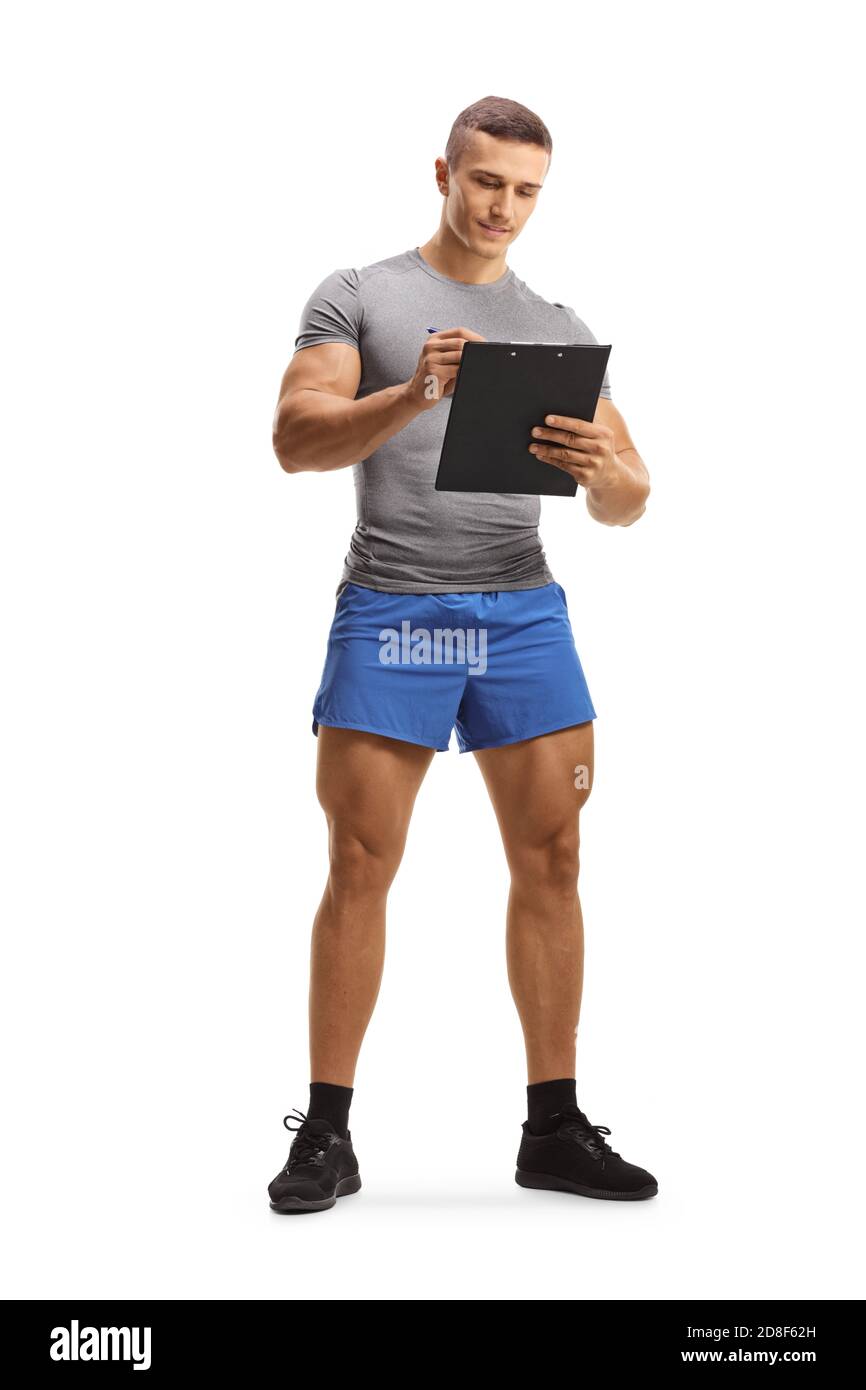 Full length portrait of a muscular young man in sportswear writing on a ...
