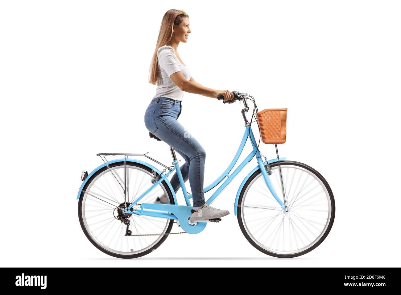 Full length profile shot of a young woman with long hair riding a ...
