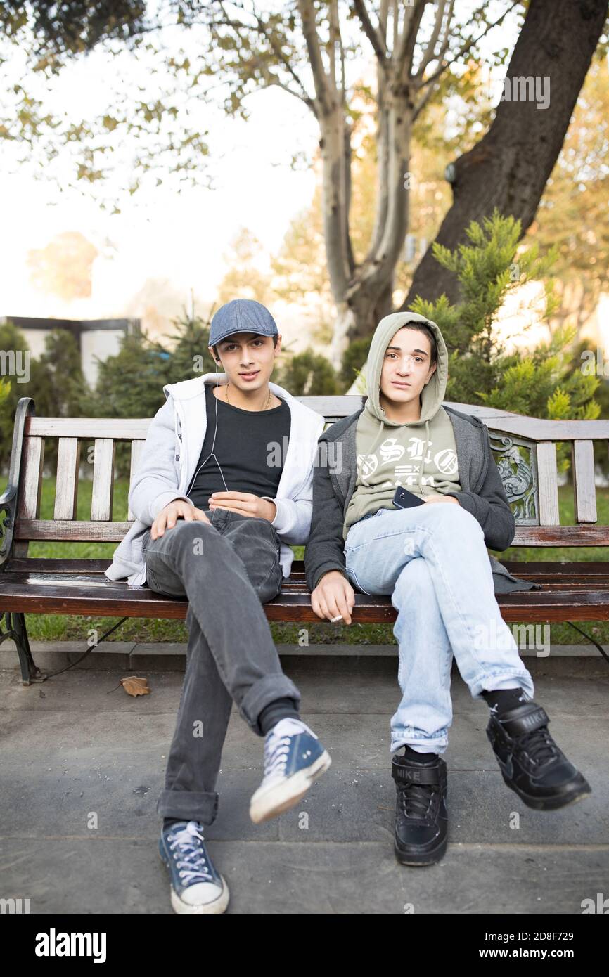 Two male friends share a park bench in central Tbilisi, Georgia ...