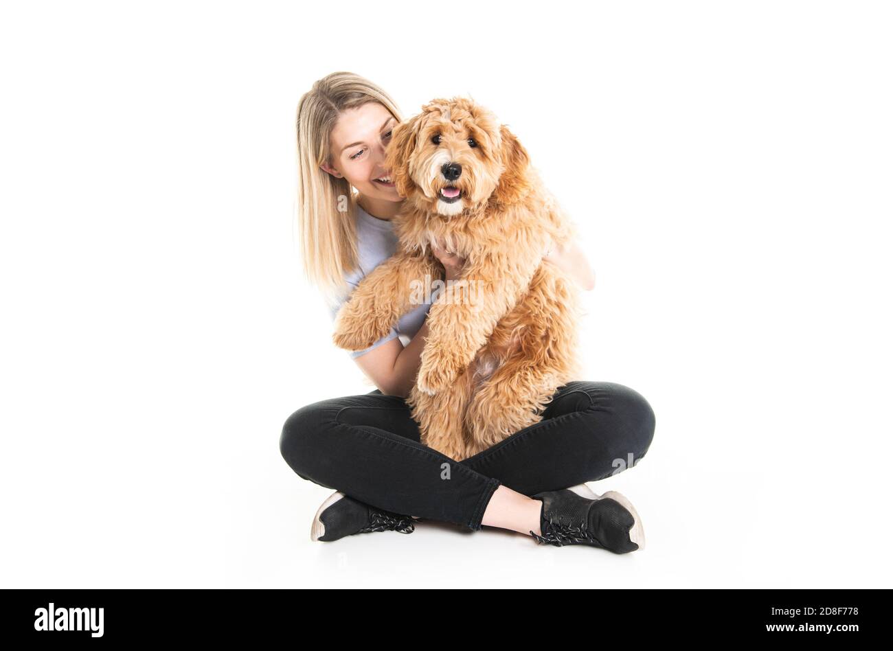 woman with his Golden Labradoodle dog isolated on white background ...