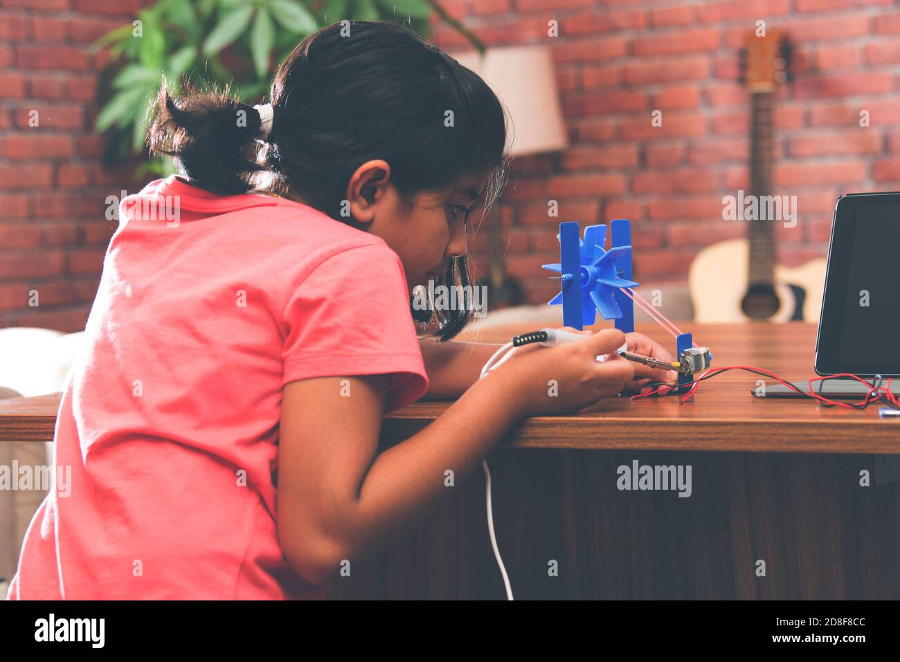 electronic experiment - Asian Indian small girl student performing ...