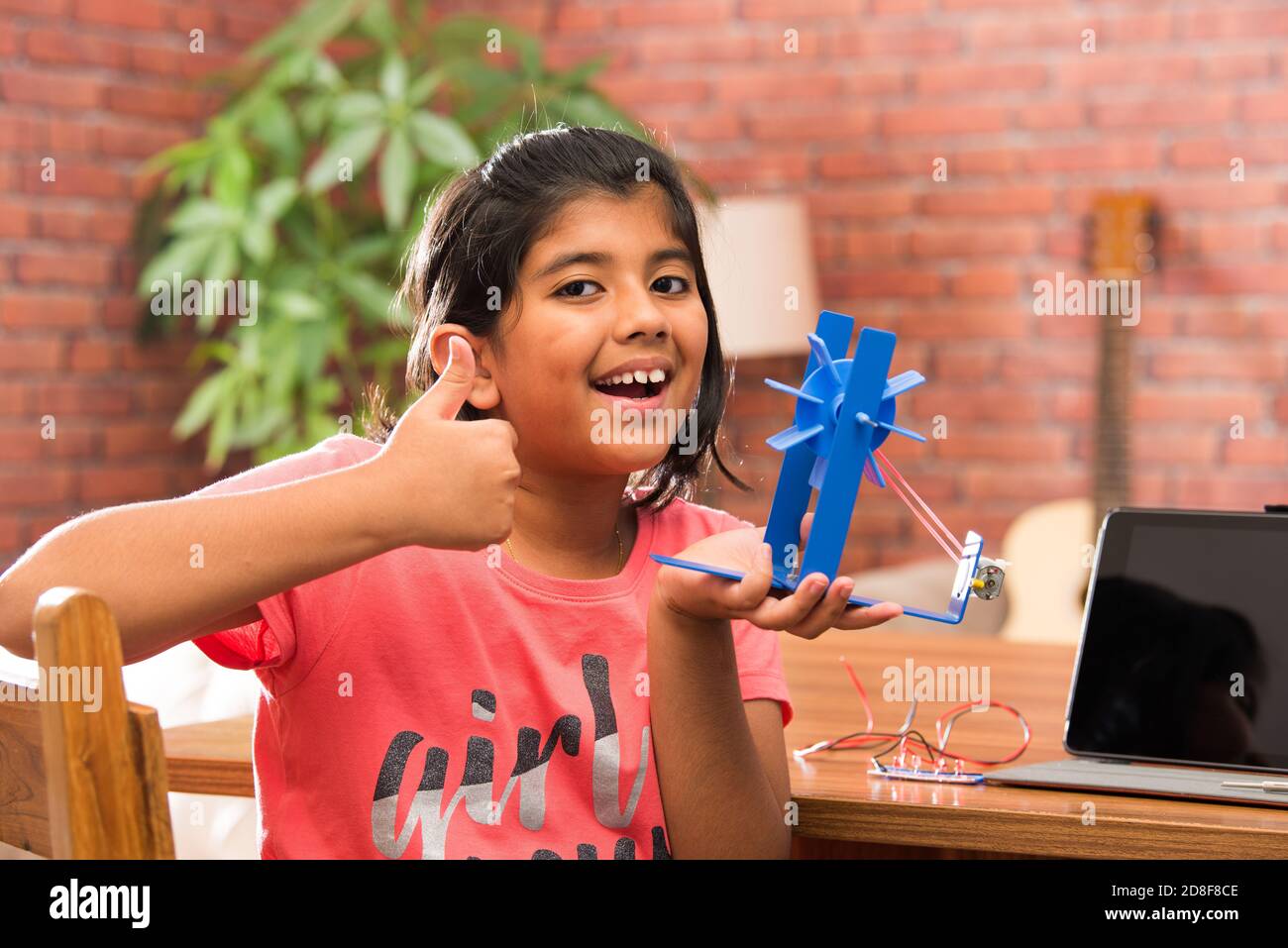 electronic experiment - Asian Indian small girl student performing ...
