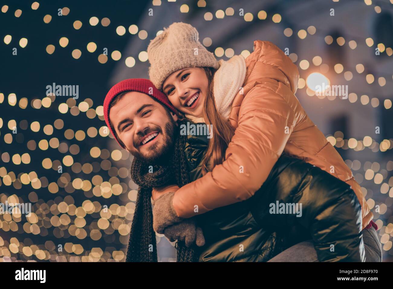 Photo of jolly guy hugging piggyback his beloved girlfriend under x-mas ...