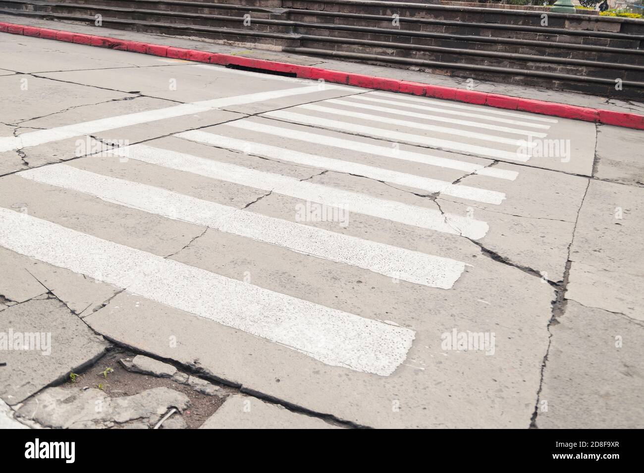 White zebra crossing lines on the old and broken road- zebra crossing ...