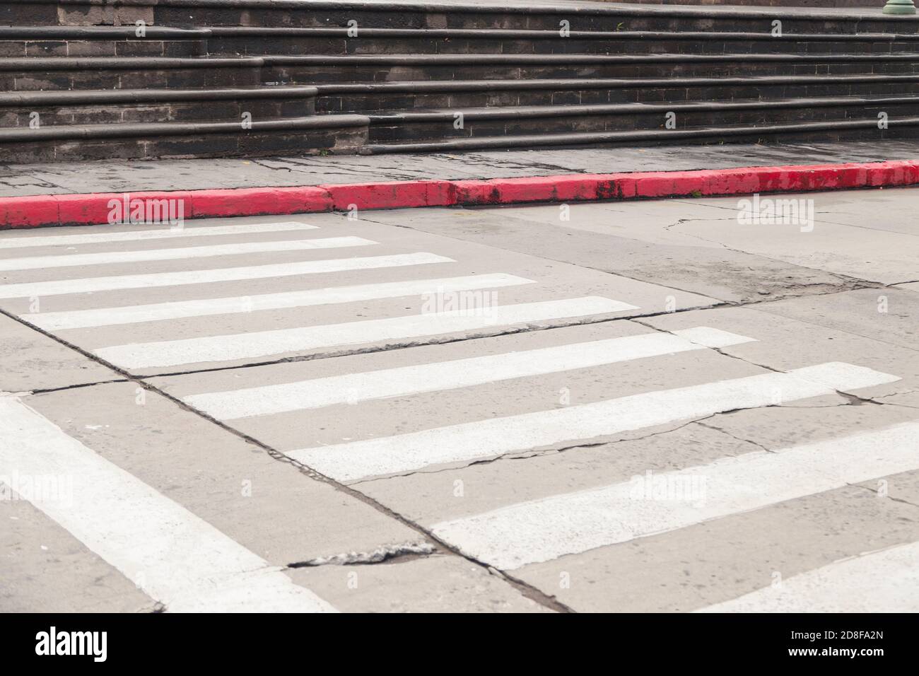White zebra crossing lines on the old and broken road- zebra crossing ...