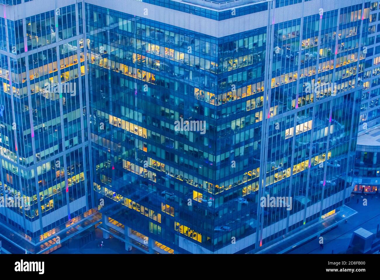 modern office building with big windows at night, in windows light ...