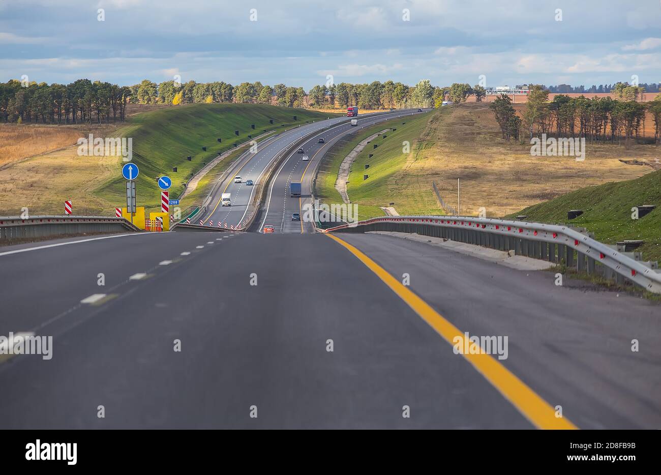 Suburban new freeway in a hilly area at the turn Stock Photo - Alamy