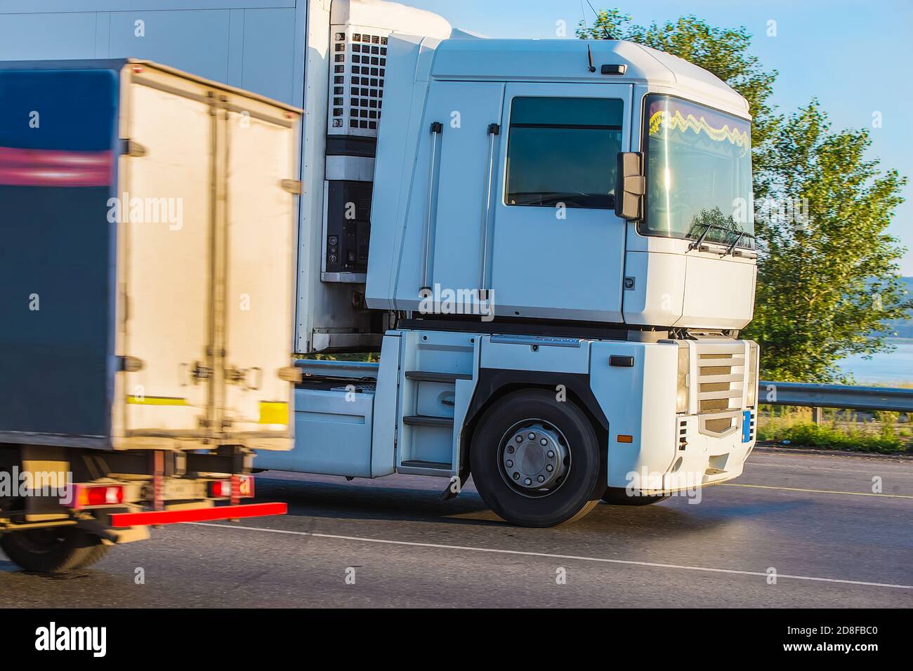 trucks transporting freight on the country highway Stock Photo - Alamy