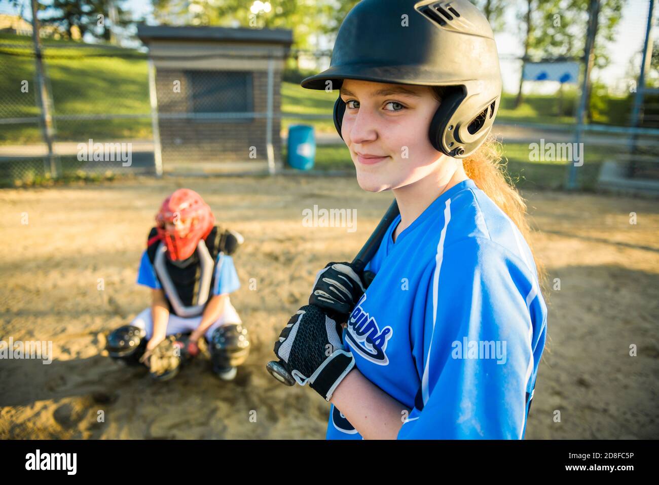 Girl baseball player with bat on the playground Stock Photo - Alamy