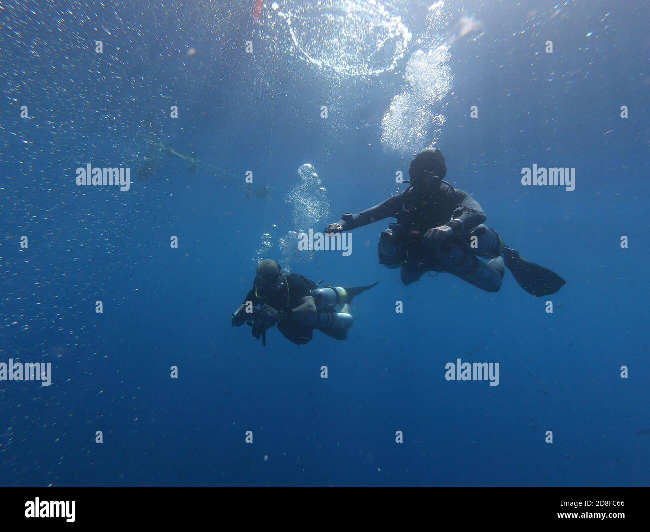 Amazing shot of scuba divers swimming underwater Stock Photo - Alamy