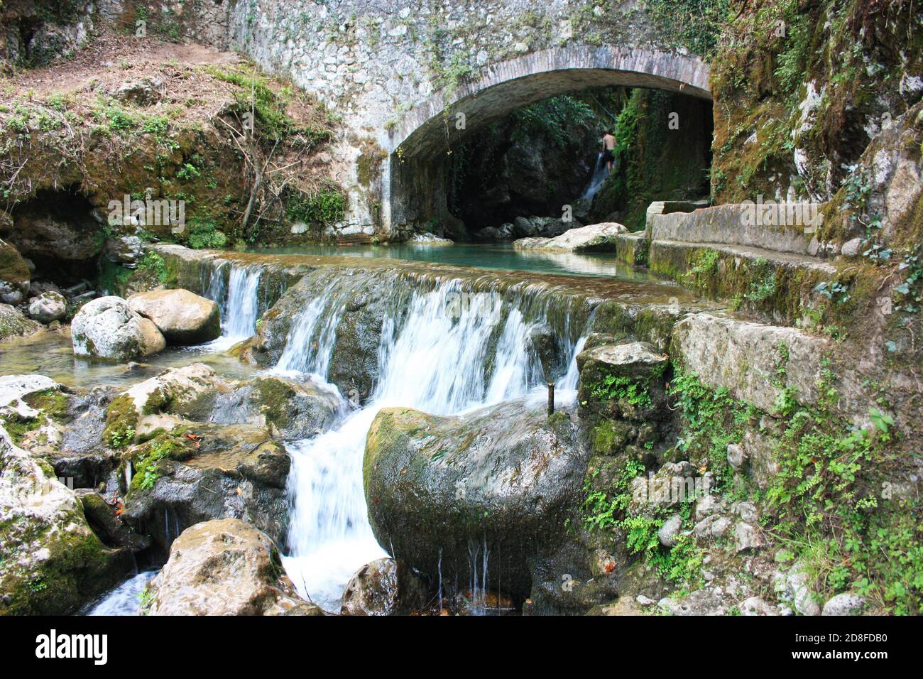 rocky bridge of candalla over the river waters in the Tuscan mountains ...