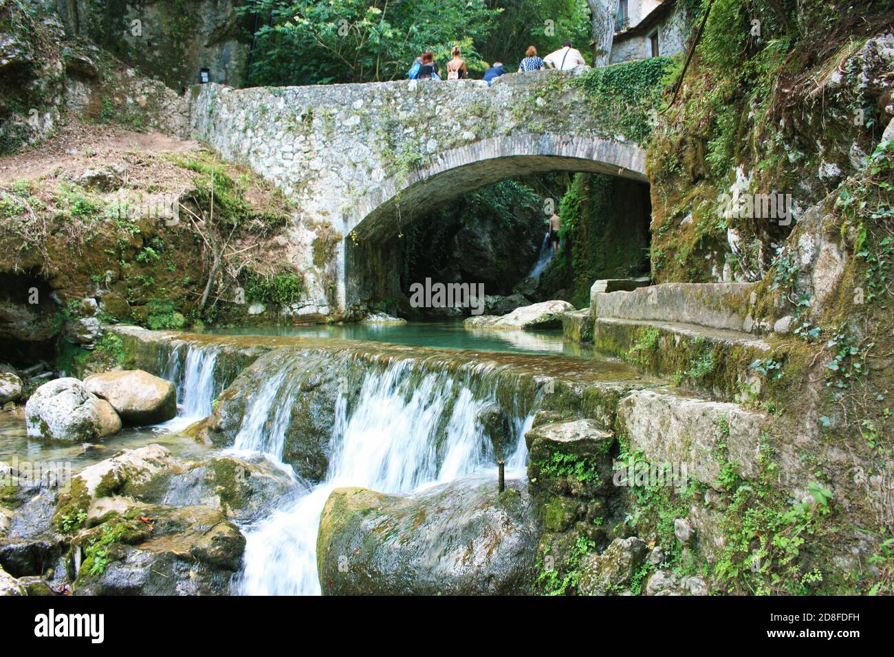 rocky bridge of candalla over the river waters in the Tuscan mountains ...