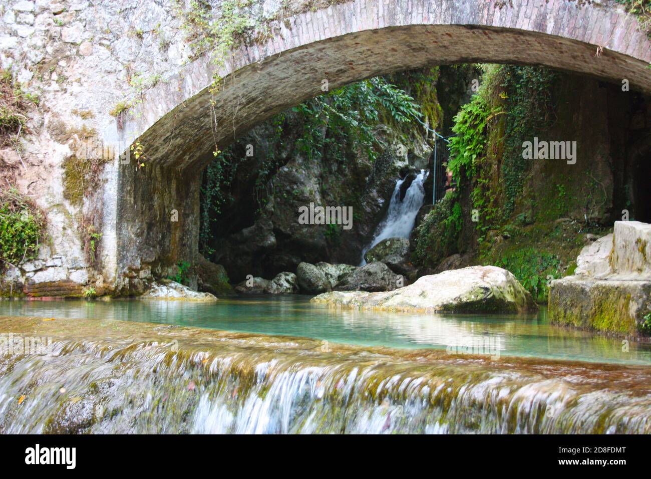 rocky bridge of candalla over the river waters in the Tuscan mountains ...