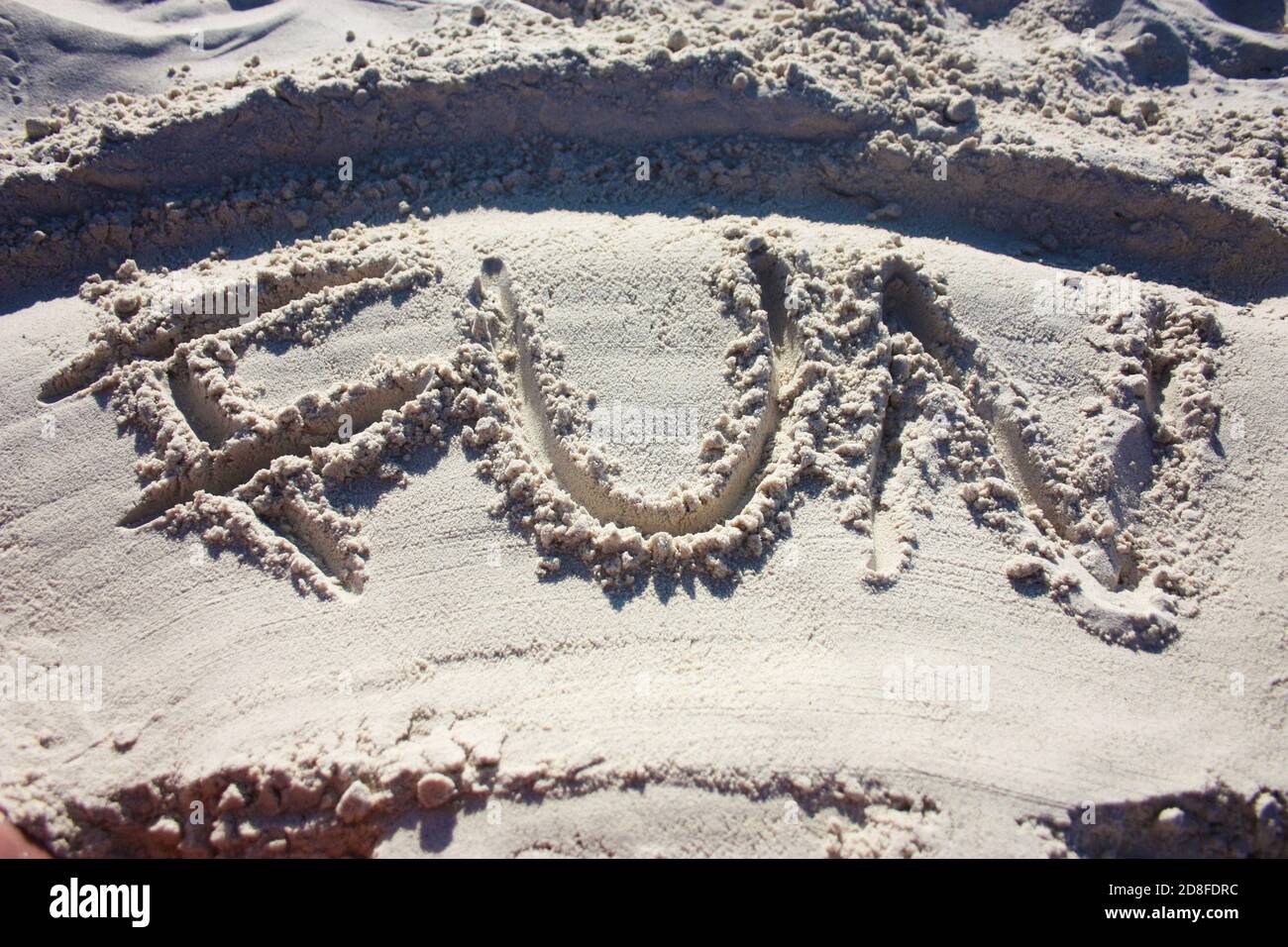 fun word written in summer on the light sand at the seaside beach in ...