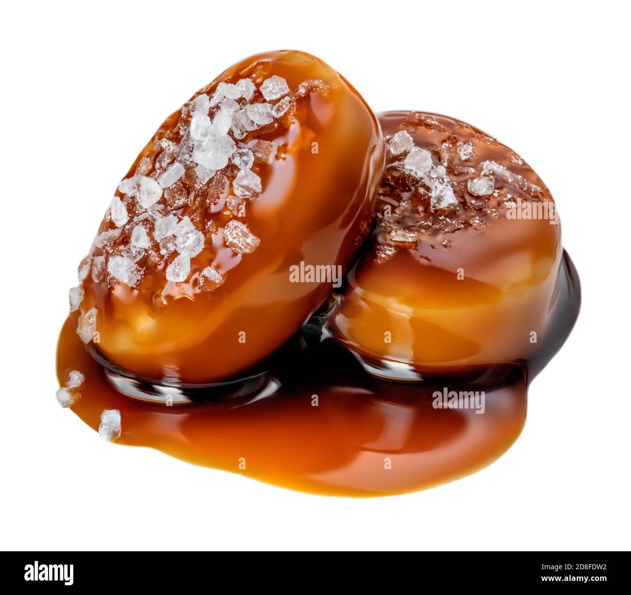Caramel candies and sauce on white background. Salted Caramel close up ...