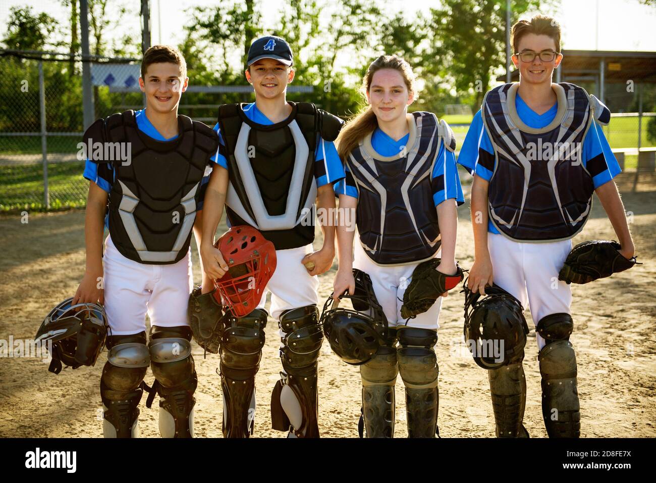 Group of baseball players catcher standing together on the playground ...