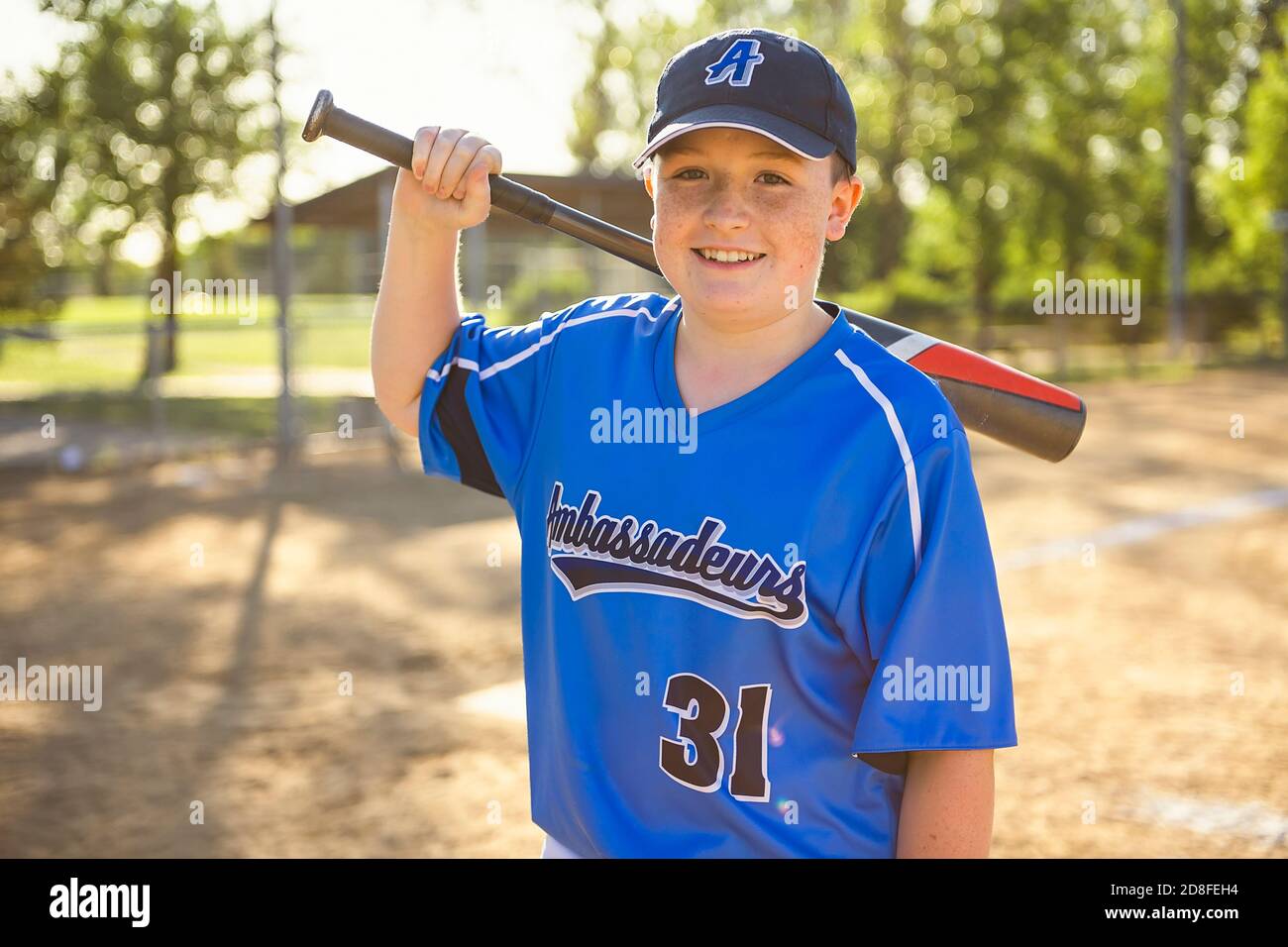 A children baseball players holding bat on the playground Stock Photo ...