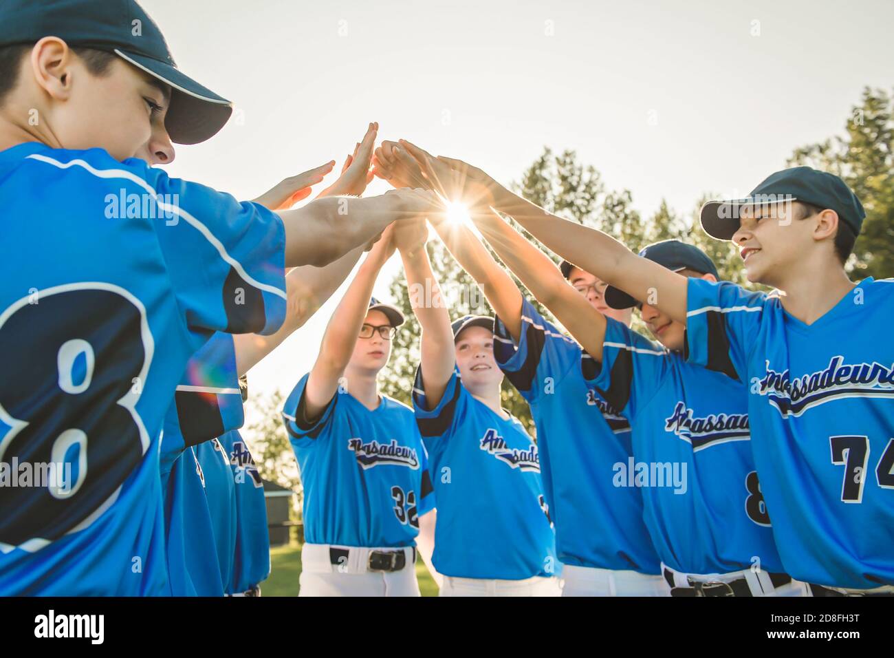 Group of baseball players standing together on the playground with hand ...